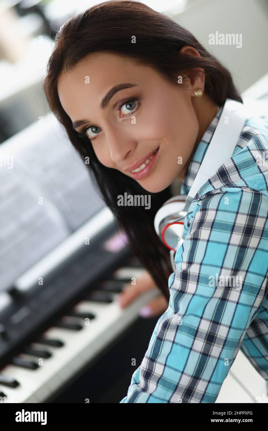 Female playing on white and black keyboards on piano, beautiful ...