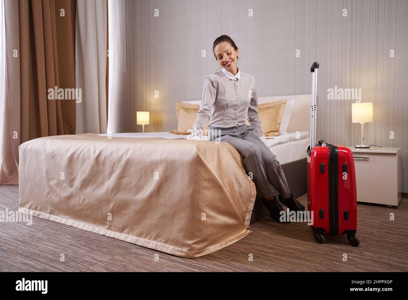 Woman enjoying her stay in hotel room Stock Photo - Alamy
