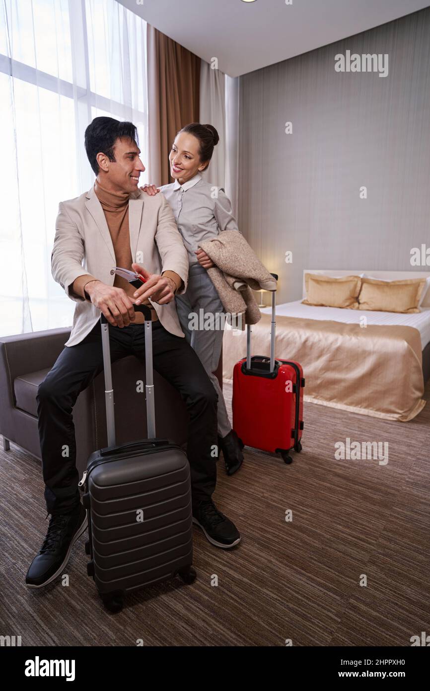 Romantic Caucasian couple with luggage in hotel room Stock Photo - Alamy