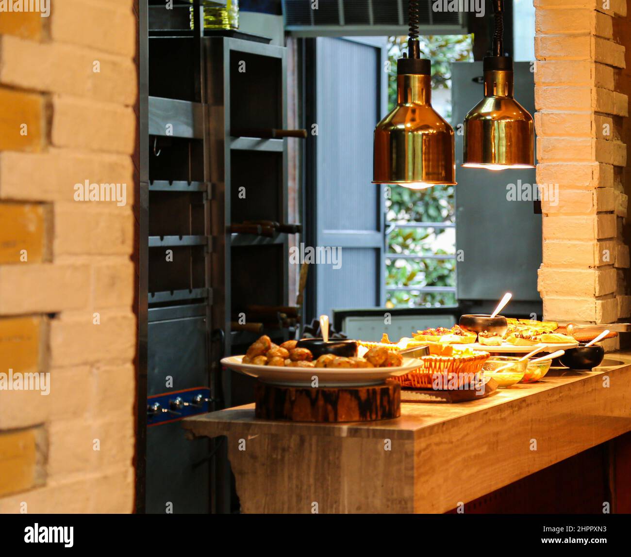 Buffet heated fried food section and kitchen ovens Stock Photo - Alamy
