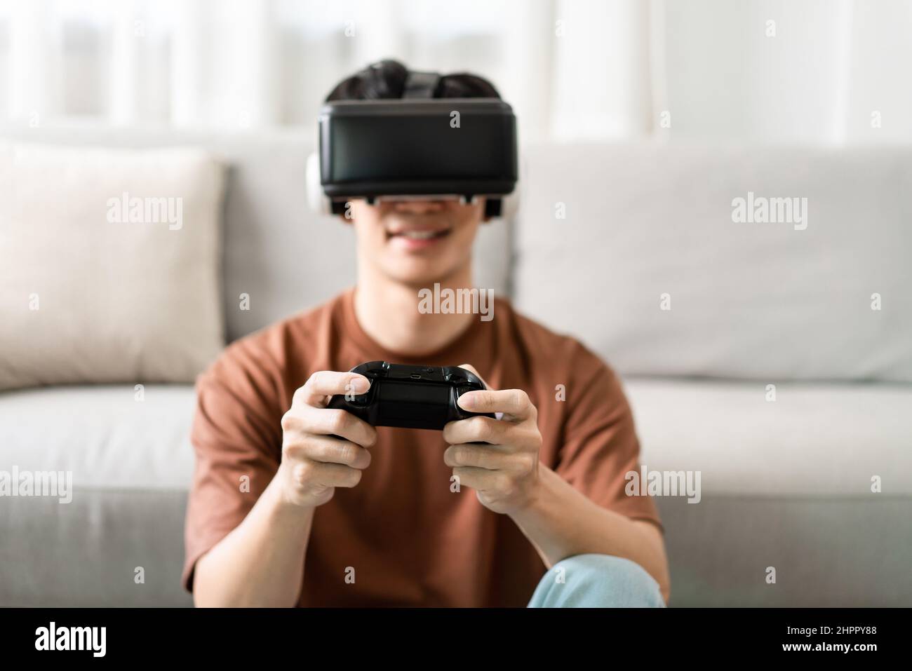 Technology Concept A man putting on a virtual reality headset and ...