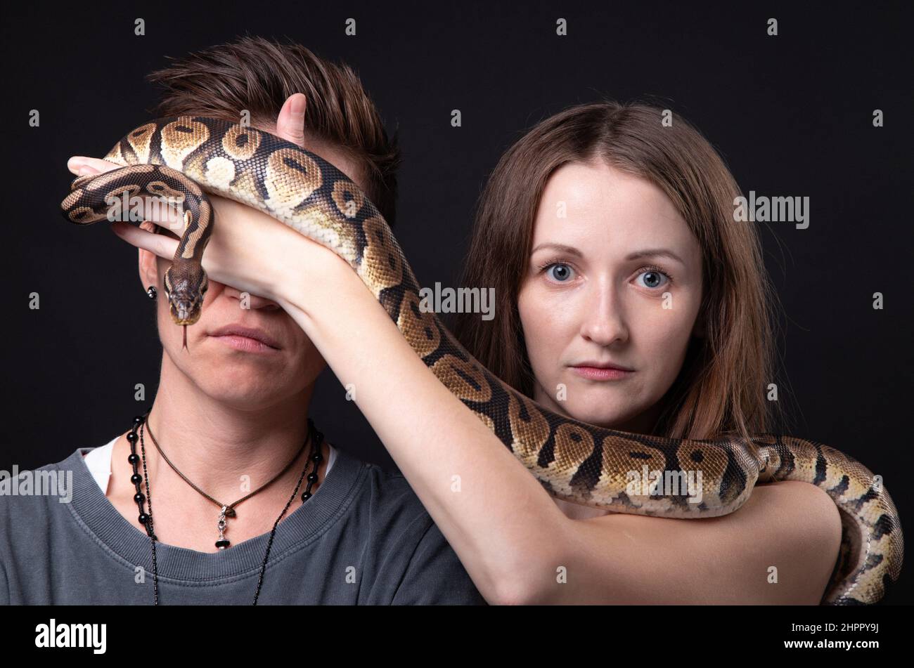 Photo of two women with python on closed eyes Stock Photo - Alamy