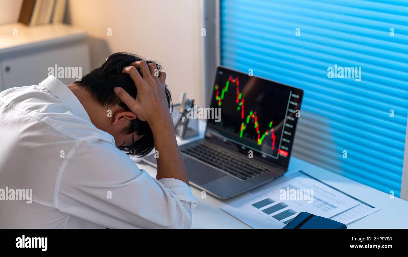 Overwork Concept The male who works in the office holding his head with ...