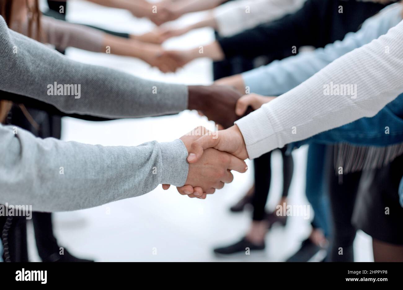 diverse young people shaking hands with each other Stock Photo - Alamy