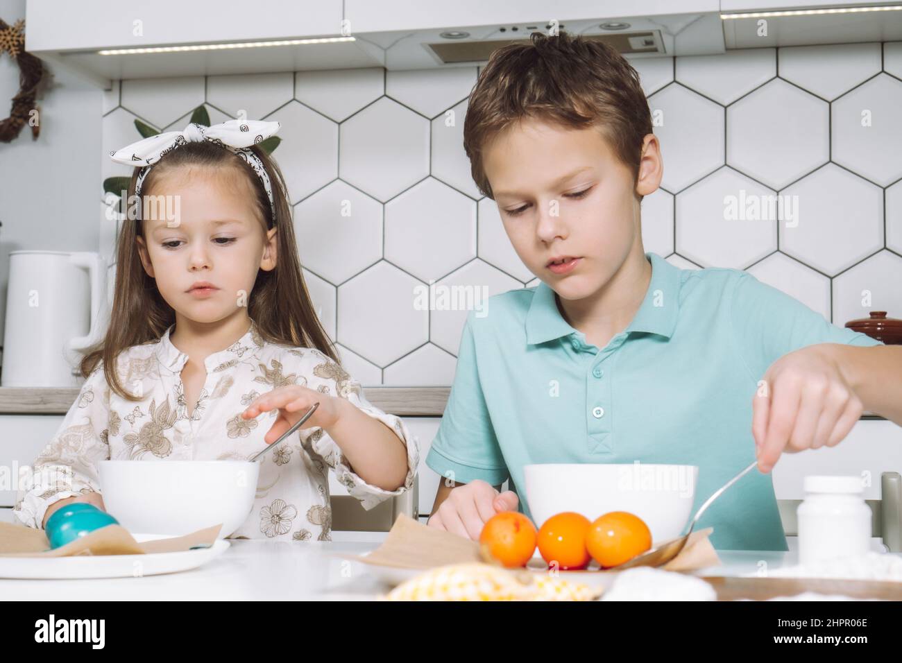 Portrait of concentrated two little children, boy, girl, multi coloring ...
