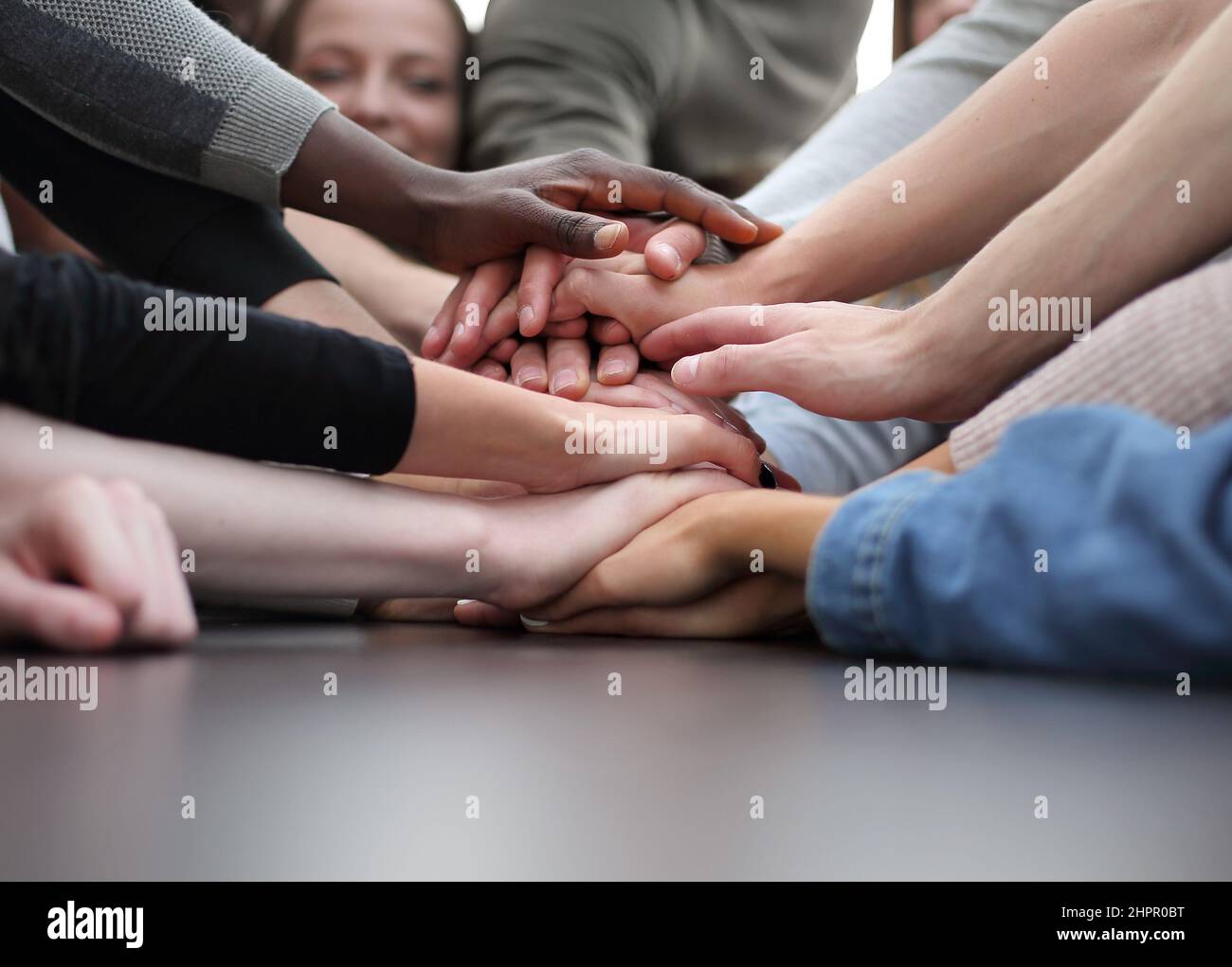 close up. a group of young making a tower of hands on the table Stock ...
