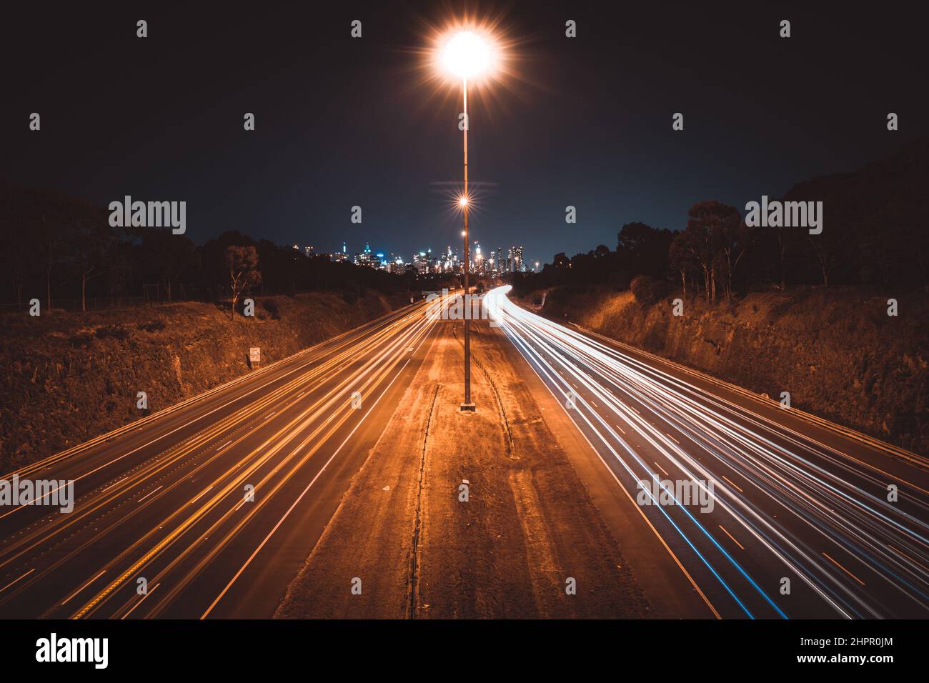 Long exposure of traffic lights and a lantern illuminating the highway ...