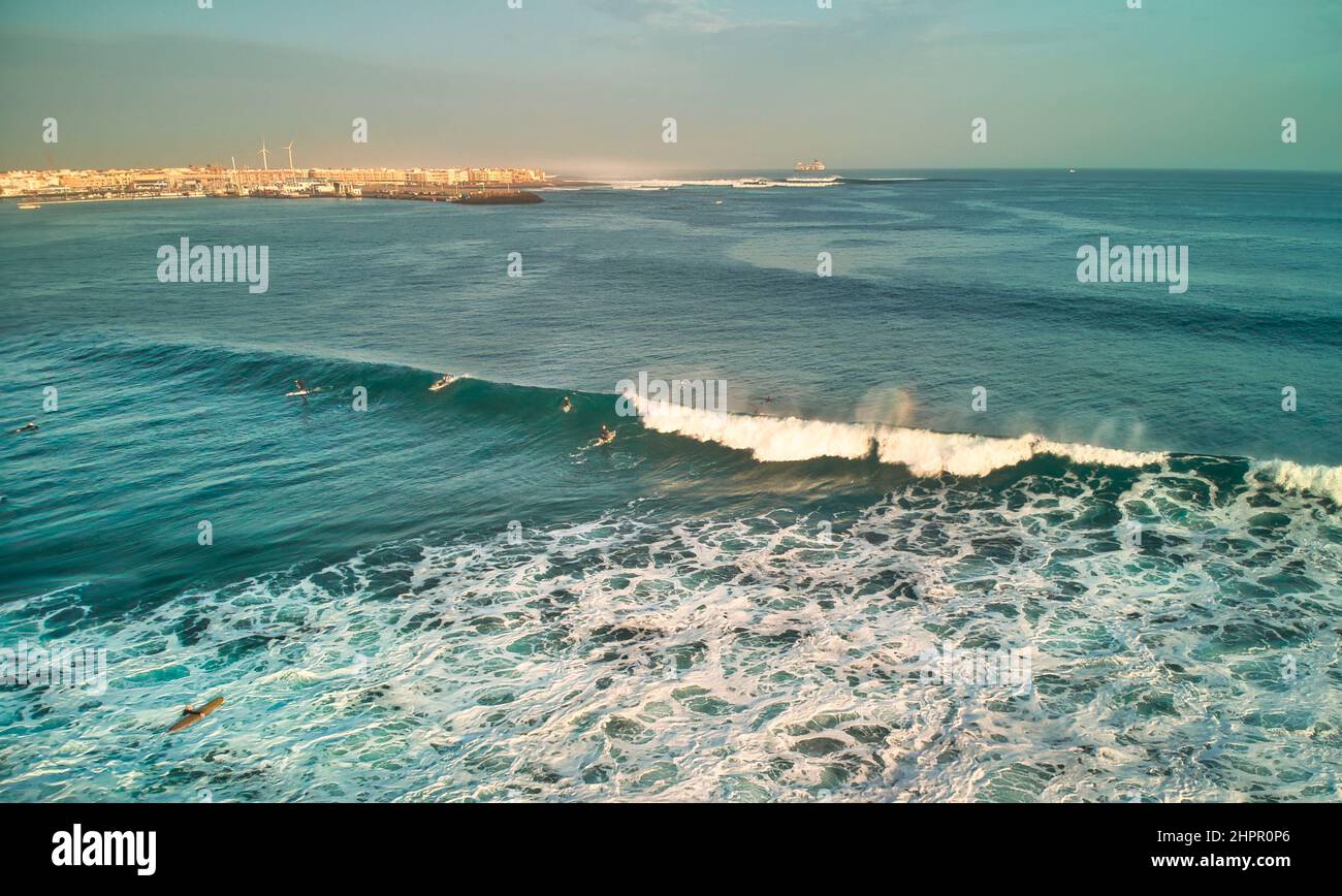 Surfers at Rocky Point Corralejo enjoying the early morning waves in Fuerteventura Stock Photo ...