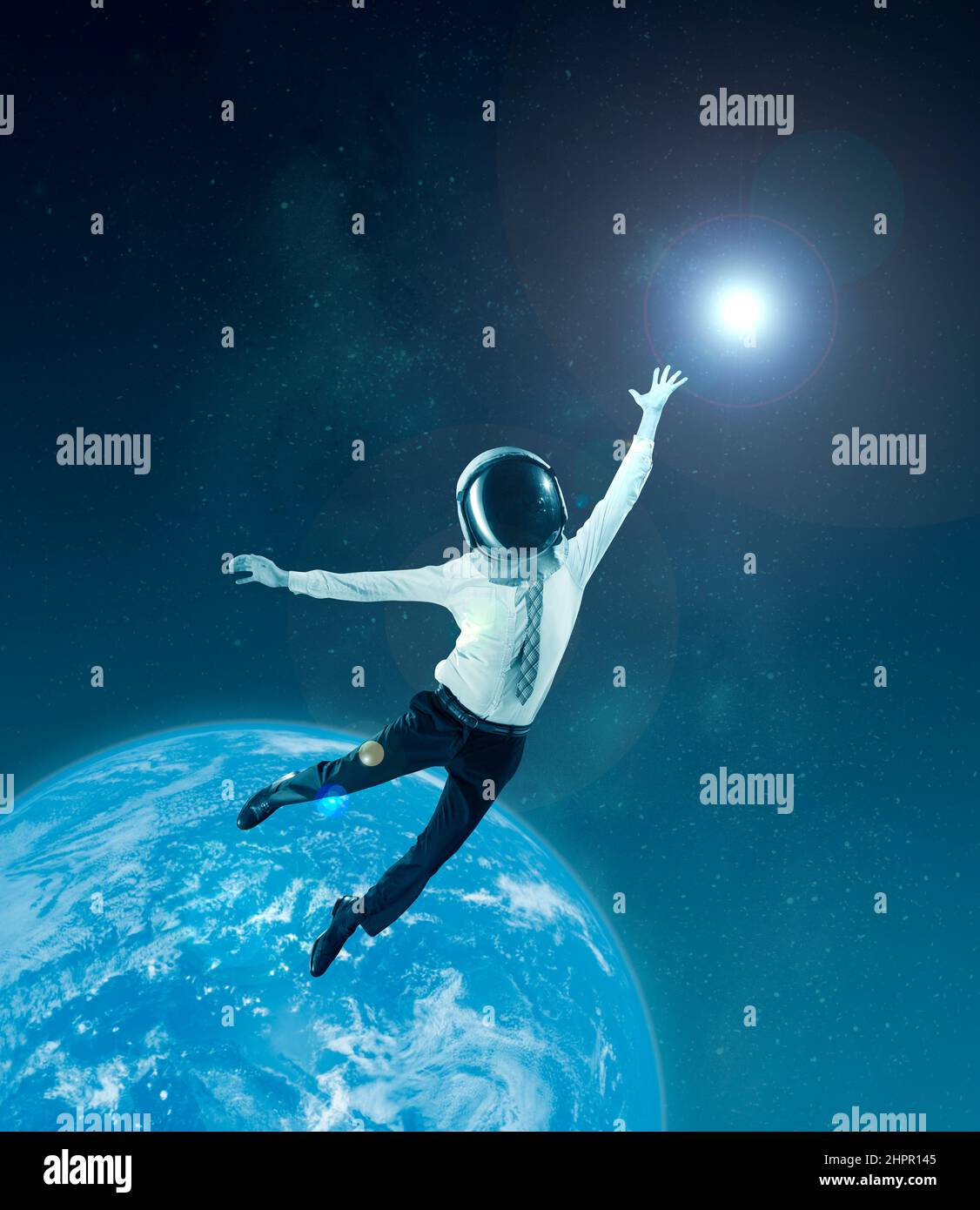 Conceptual creative artwork with businessman in helmet flying at outer ...