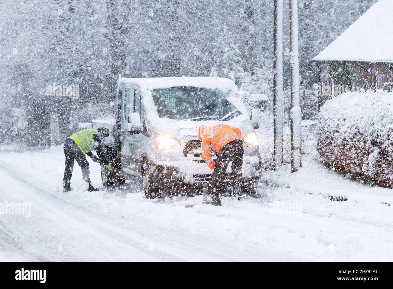 Clearing snow away from stuck vehicle hi-res stock photography and ...