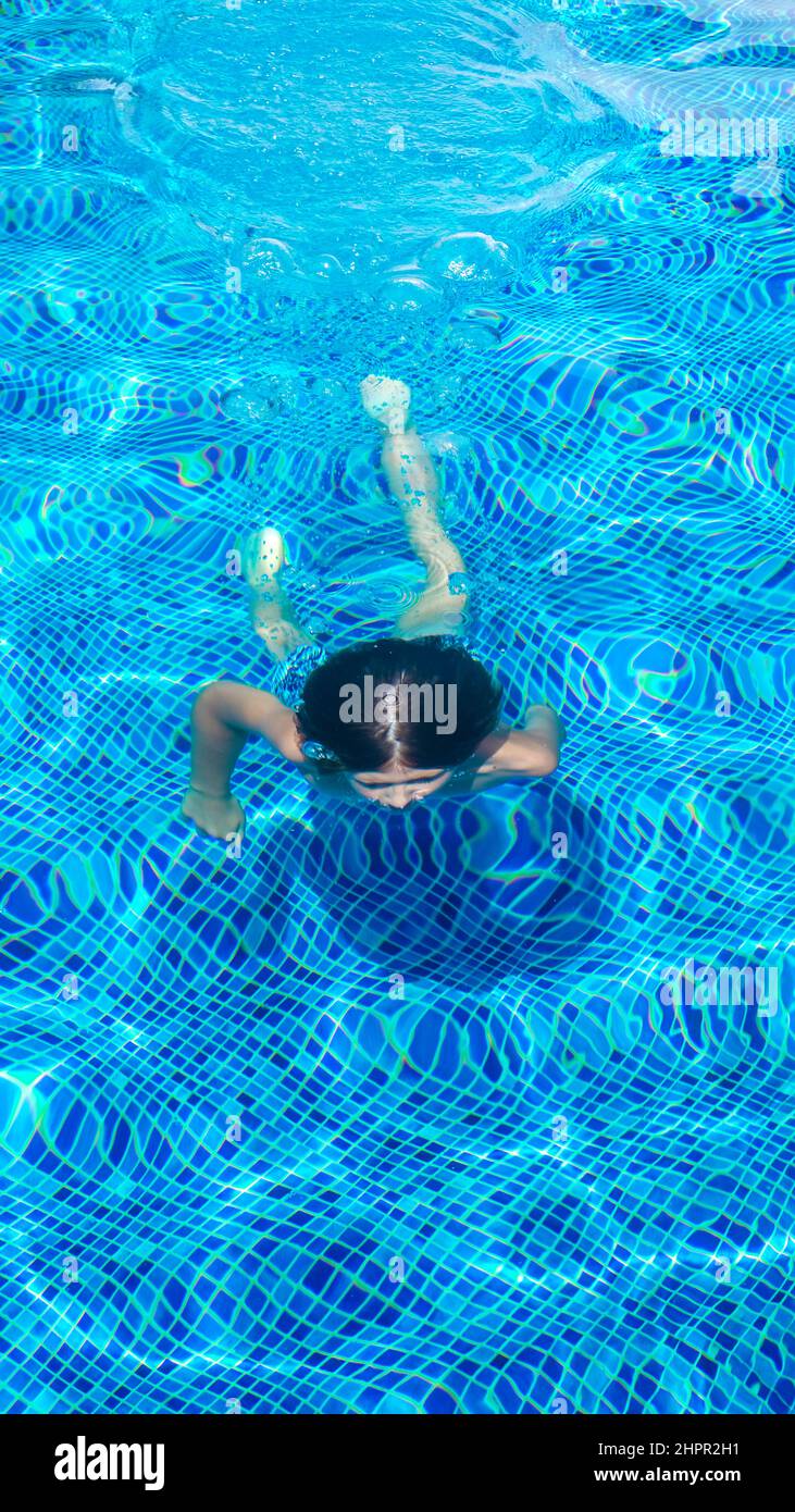 Boy in the outdoor swimming pool. Teenager in the swimming pool. Summer ...