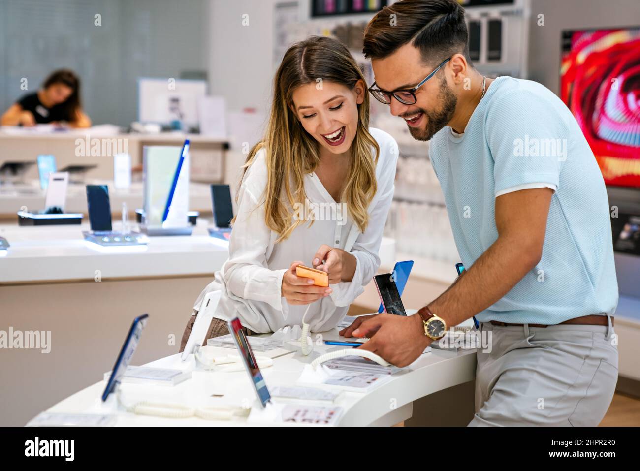 Tech shopping device gadget concept. Happy young people buying a new ...