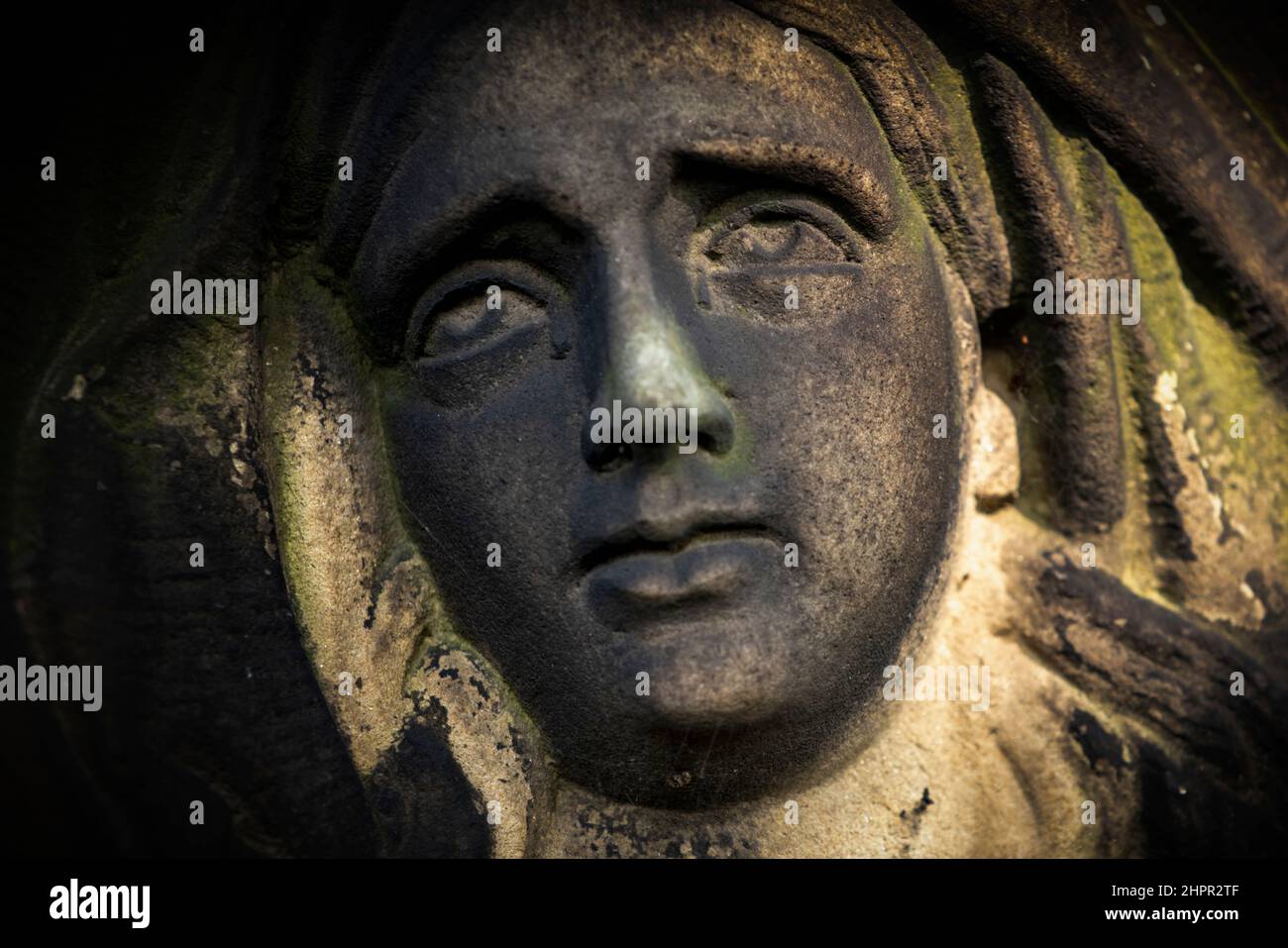Fragment of an ancient statue of Virgin Mary. Vintage sculpture of sad ...
