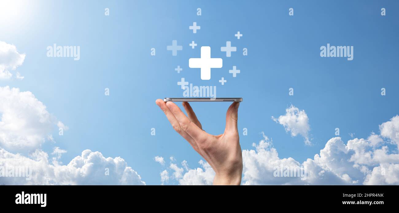 Male hand holding plus icon on blue background. Plus sign virtual means ...