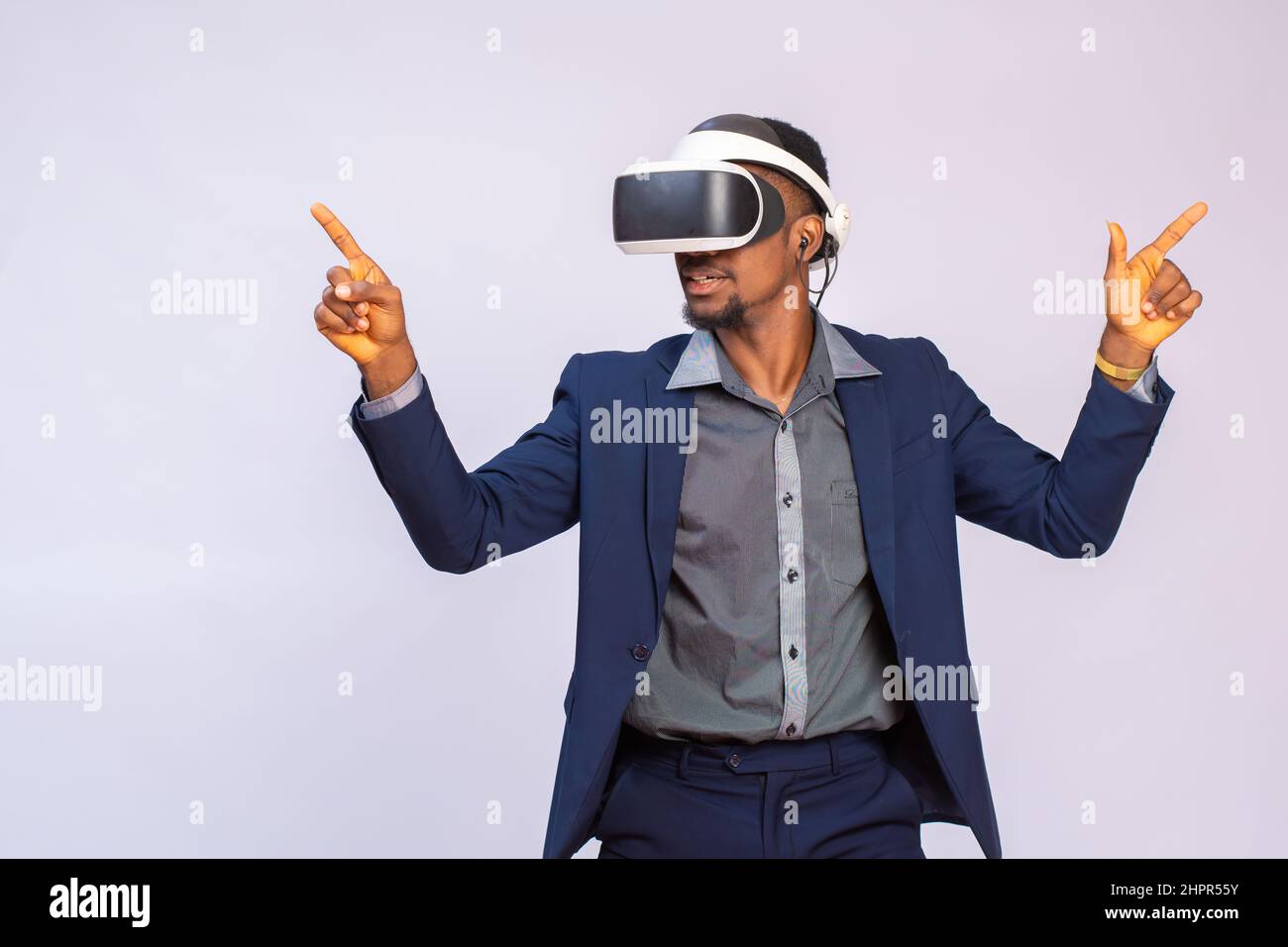 Handsome African man in a costume using VR glasses. Virtual reality ...