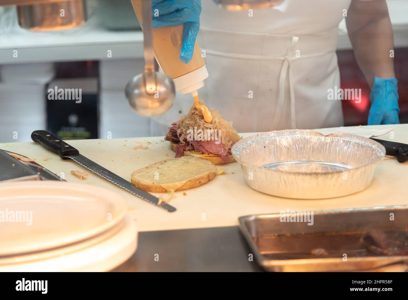 Cook preparing a Reuben sandwich Stock Photo - Alamy