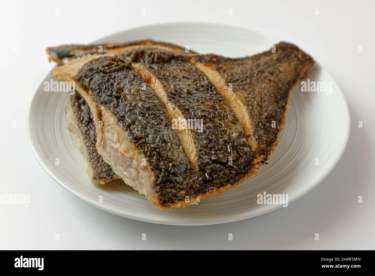 Grilled flounder on a white background Stock Photo - Alamy