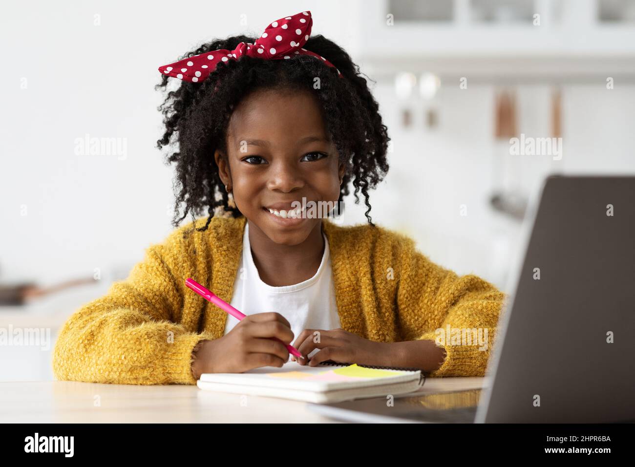 Cute Black Girl Writing With Pen In Notepad And Smiling At Camera Stock ...