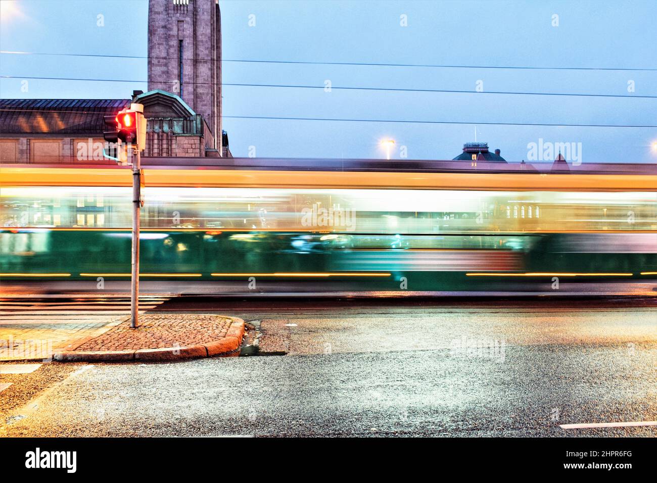 Public transport in Helsinki downtown. Green tram mooving fast. Panning ...
