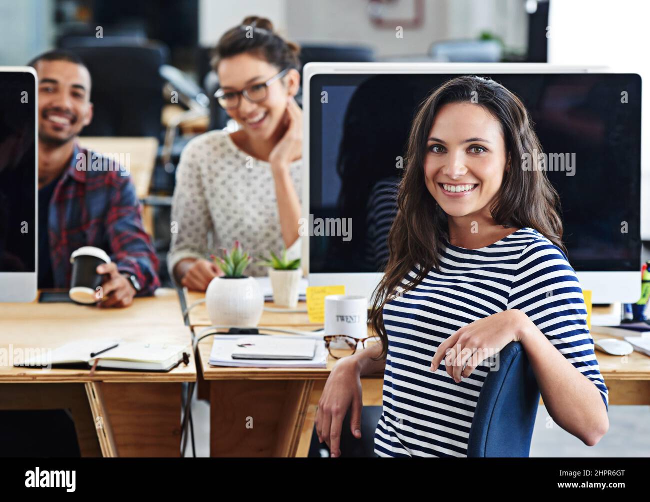Make creativity a job. Portrait of a group of young office workers ...