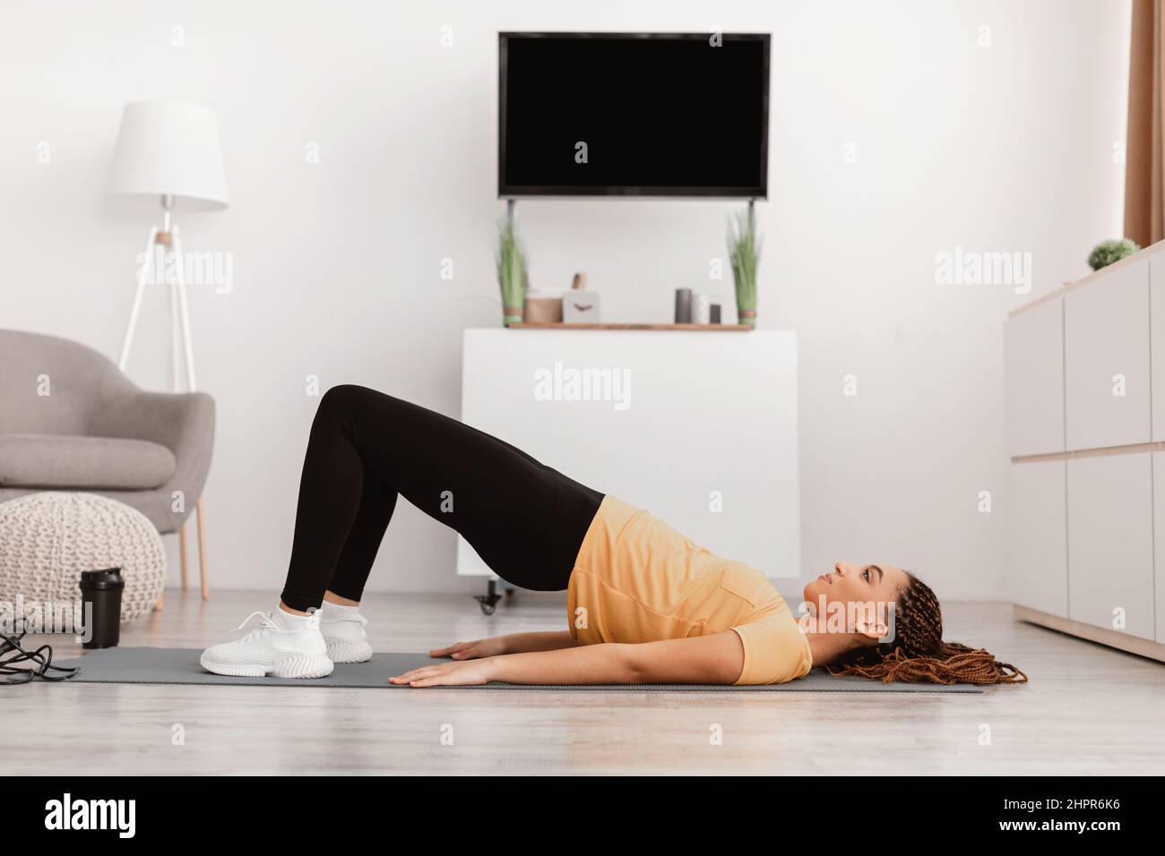 Fitness Woman With Braids Doing Bridge Exercise Training At Home Stock ...