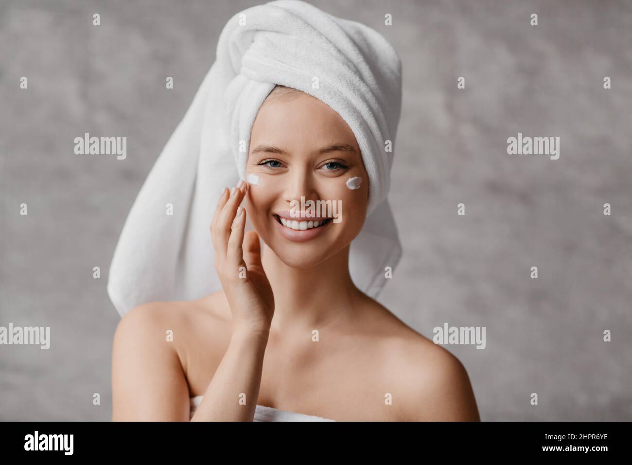 Perfect, healthy skin concept. Happy pretty lady wrapped in towel ...