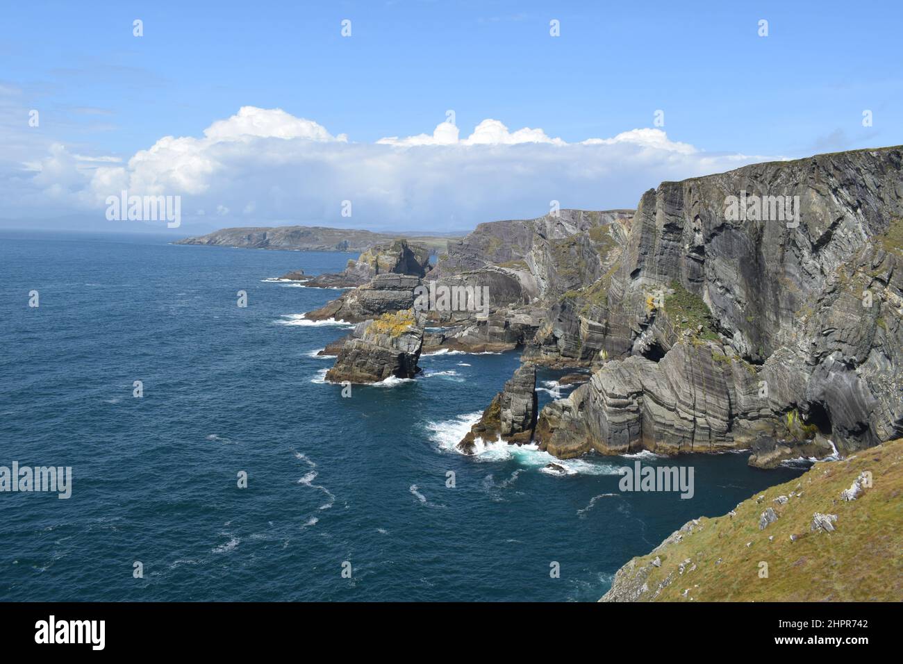Mizen Head cliffs panorama on ocean blue waters with waves. Summer ...