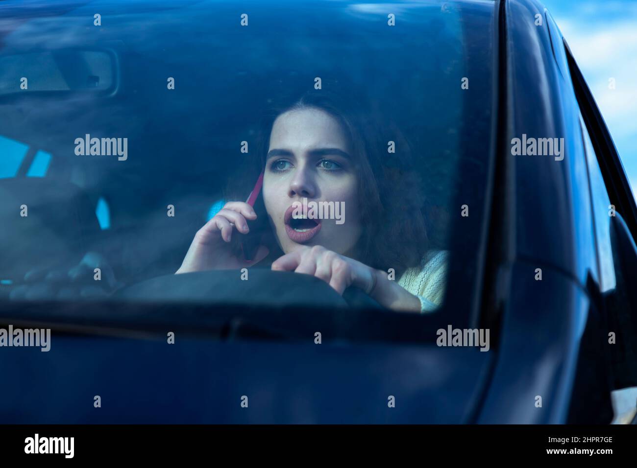 Mobile phones and driving safety concept. Danger of accident when the ...