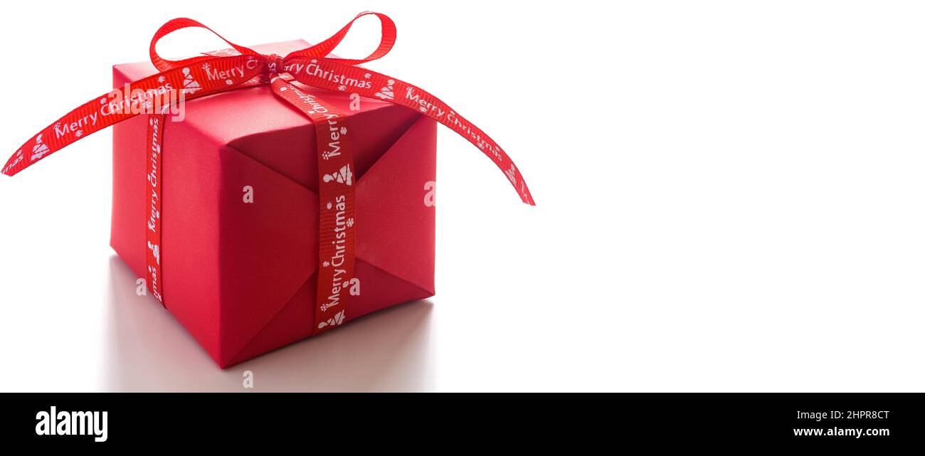 Christmas gift wrapped in red wrapping paper Side view. Copy space ...