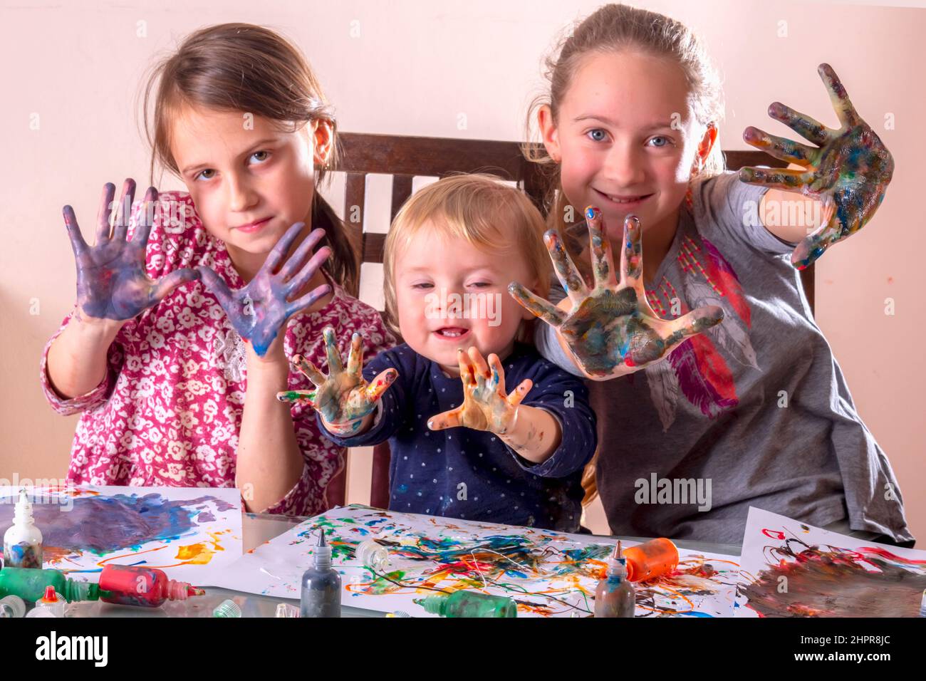 Happy children with colorful painted hands drawing and having fun ...