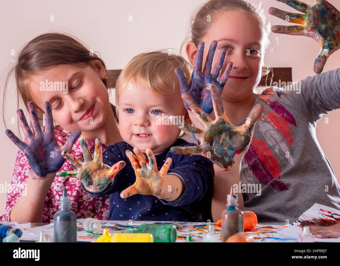 Kids love to draw. Happy children with painted hands drawing and having ...