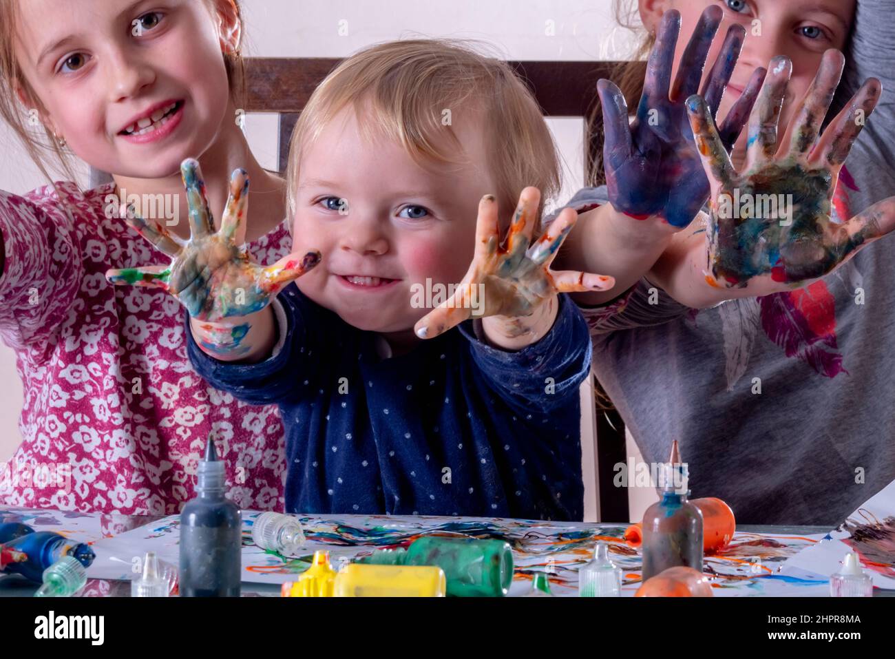 Kids love to draw. Happy children with painted hands drawing and having ...