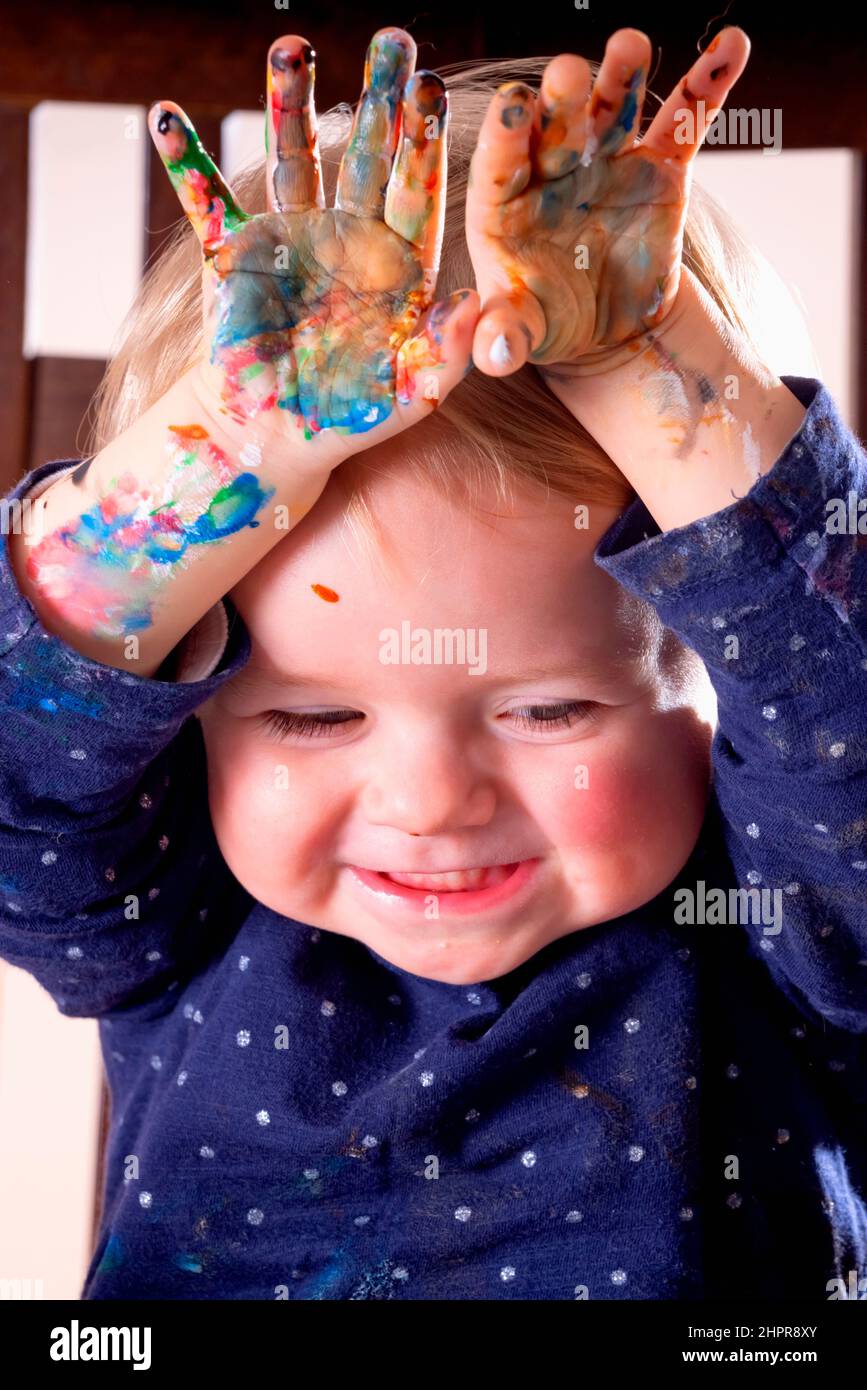 Funny portrait of little child girl with painted hands Stock Photo - Alamy