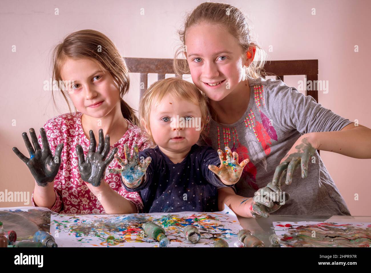 Happy beautiful children with hands in the paint Concept: carefree ...