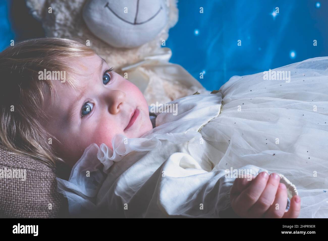 Little cute child girl falls asleep in bed. Happy carefree childhood ...