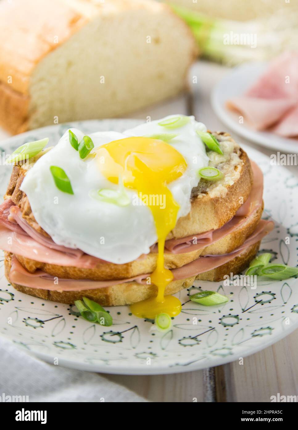 A French Croque Monsieur sandwich topped with a fried egg with runny ...