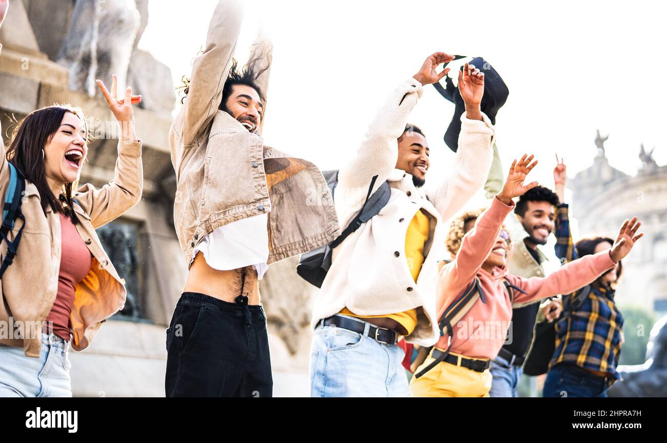 Multicultural students jumping and cheering by the end of school at ...