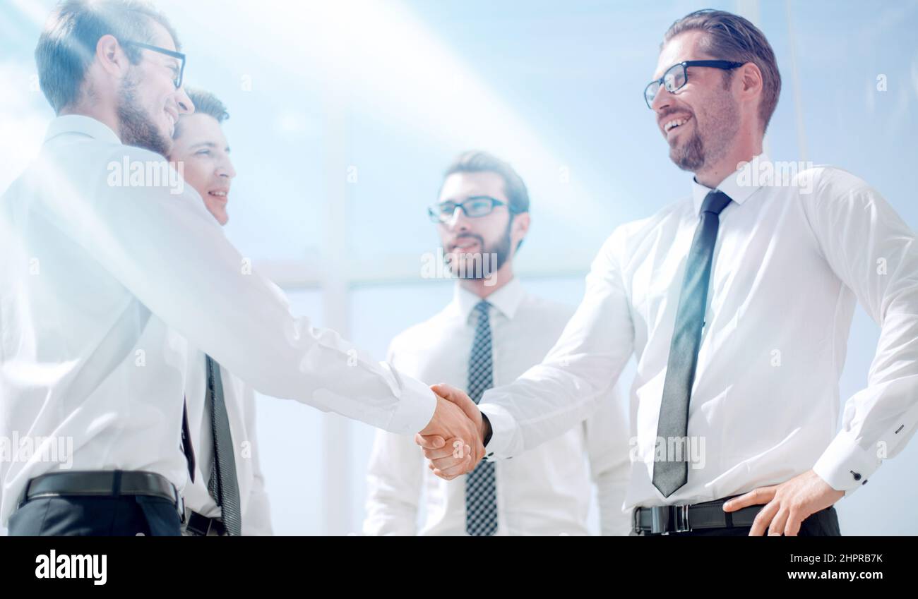 handshake of young business partners standing in the office Stock Photo - Alamy