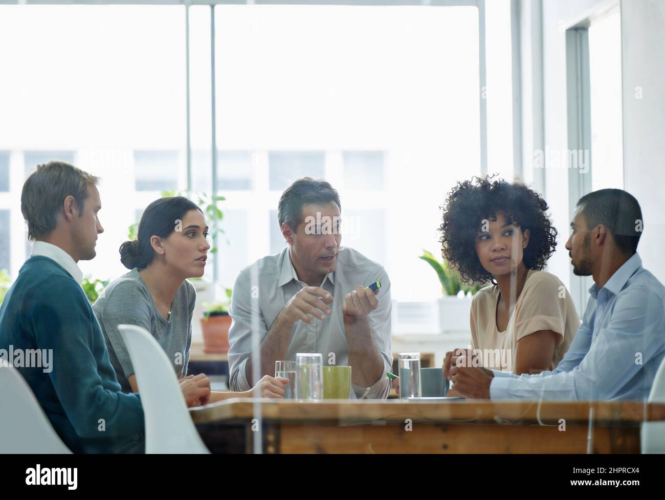 There is no I in teamwork. Cropped shot of a group of colleagues in a ...