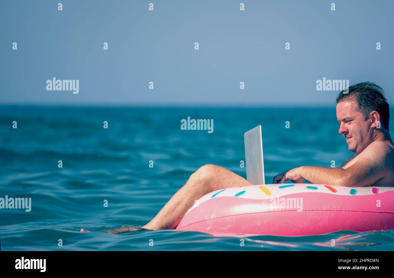 Working anywhere and any time concept. Young man working, using laptop ...