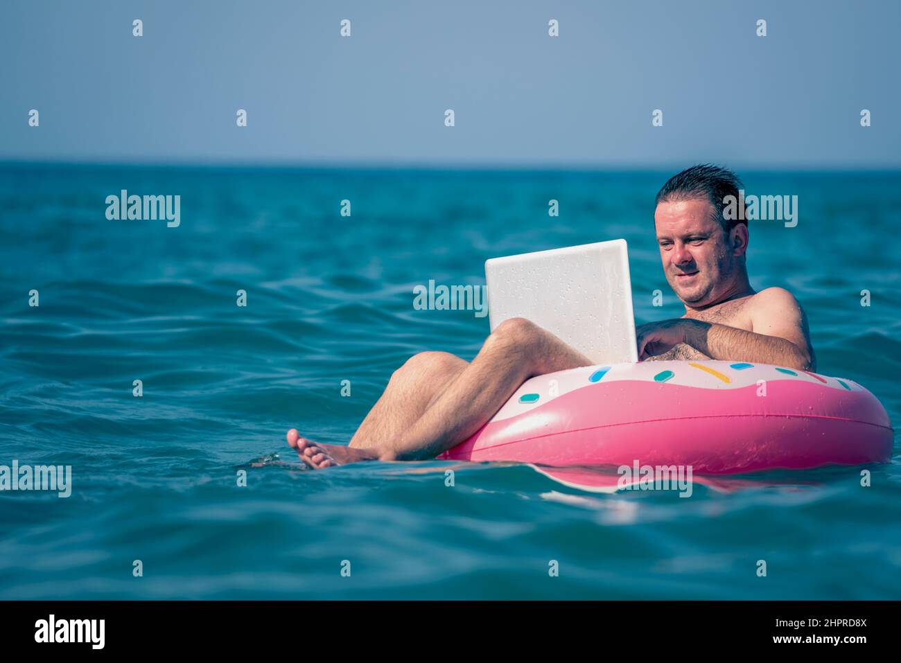 Working anywhere and any time concept. Young man working, using laptop ...