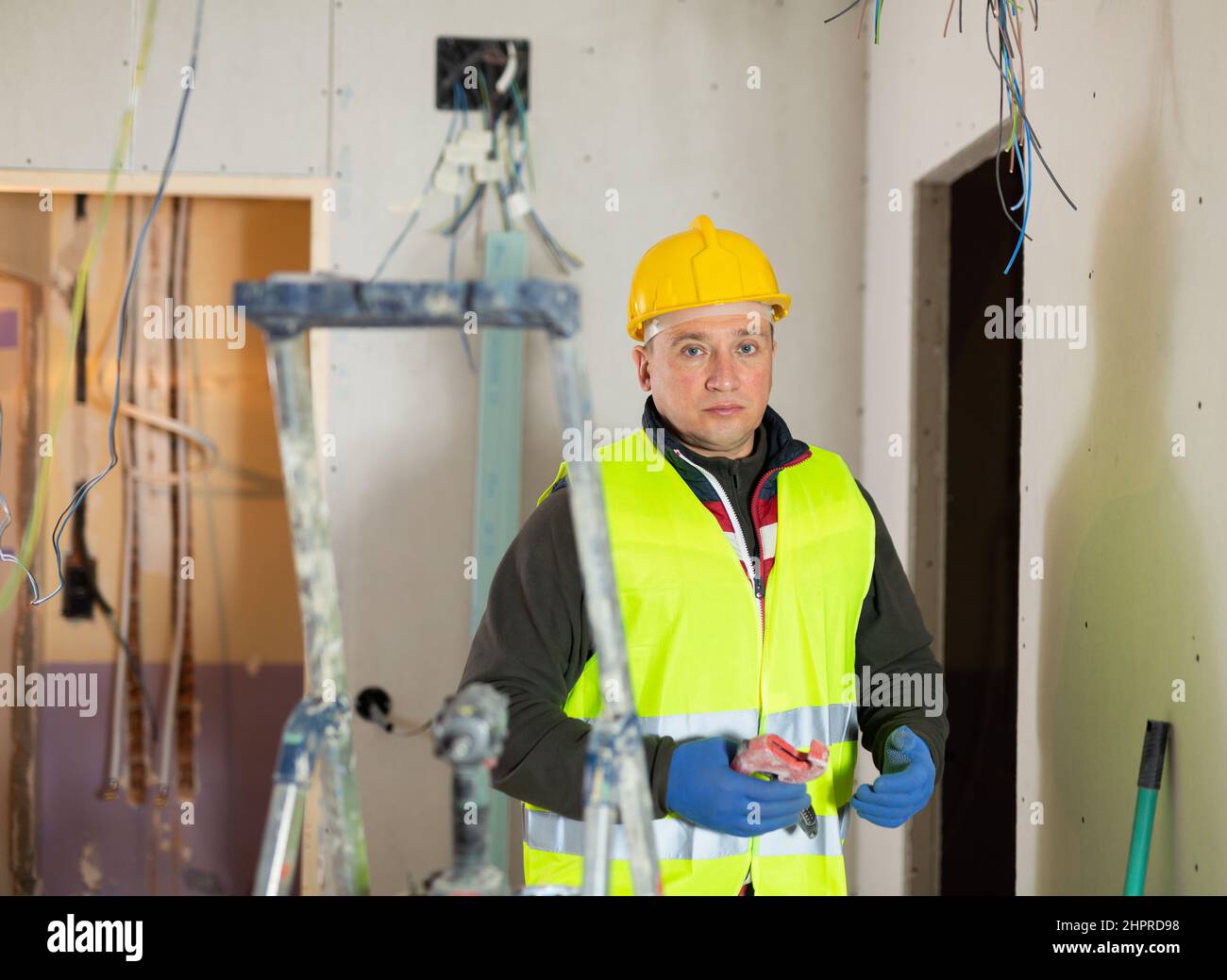 Electrician working with wires in apartment Stock Photo - Alamy