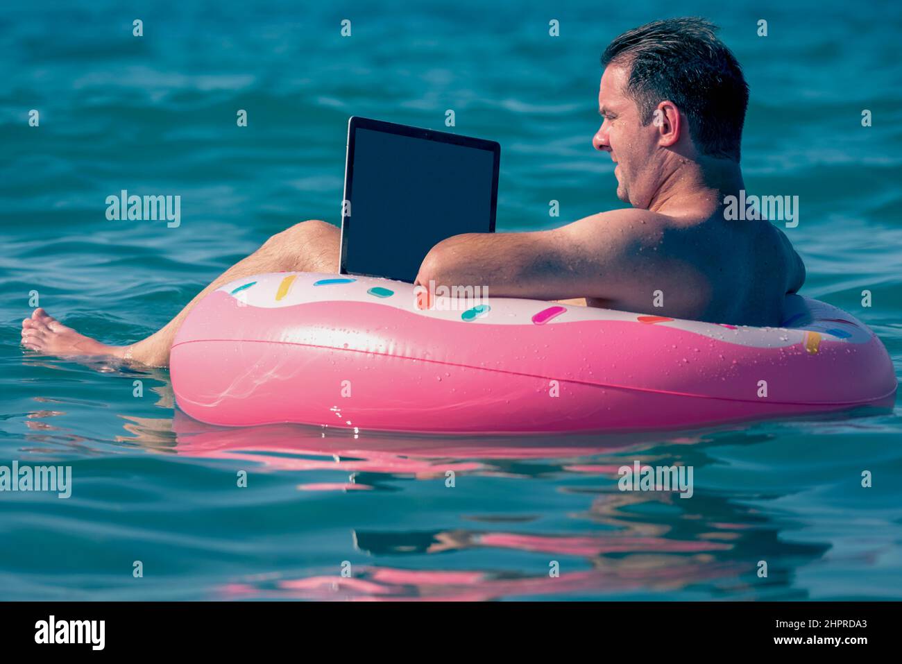 Working anywhere and any time concept. Young man working, using laptop ...