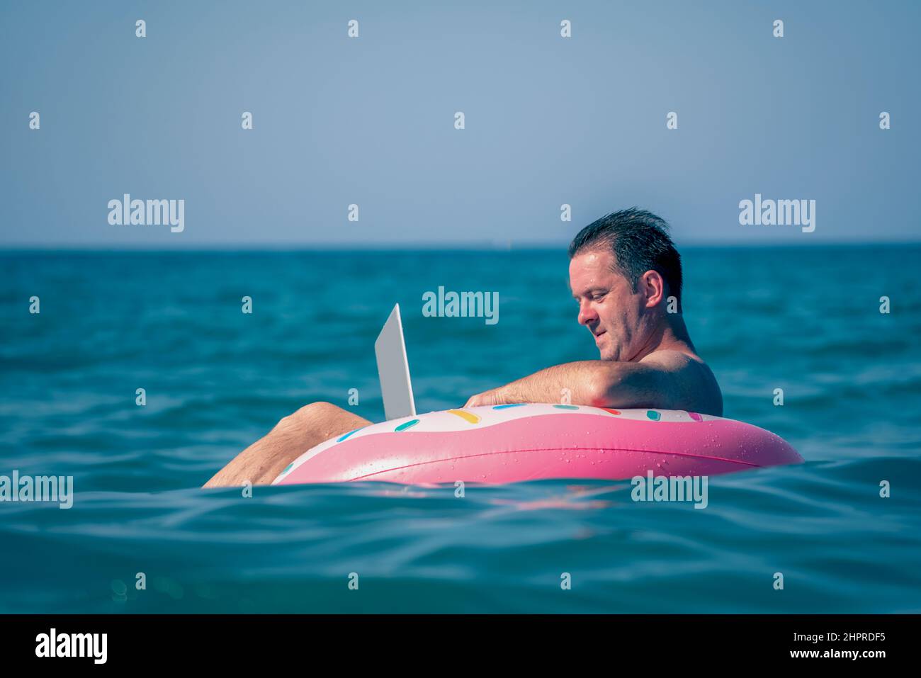 Working anywhere and any time. Portrait of man working, using laptop ...