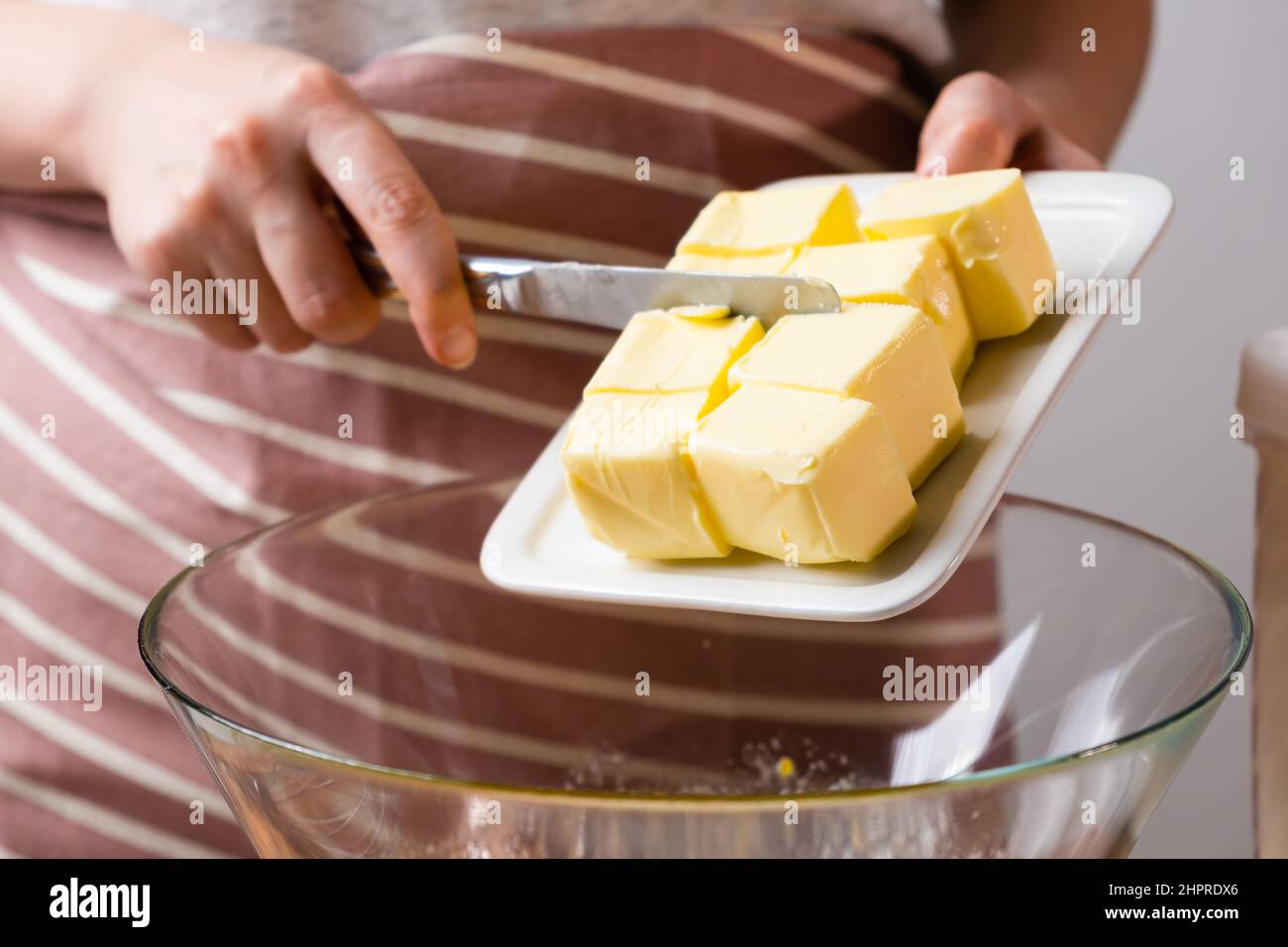 The dough preparation process. Female hands add butter into the mixing ...