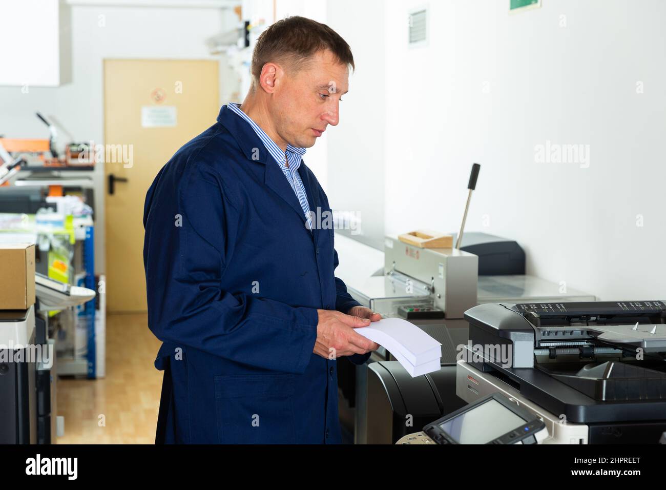 Service engineer of the printing house during work Stock Photo - Alamy