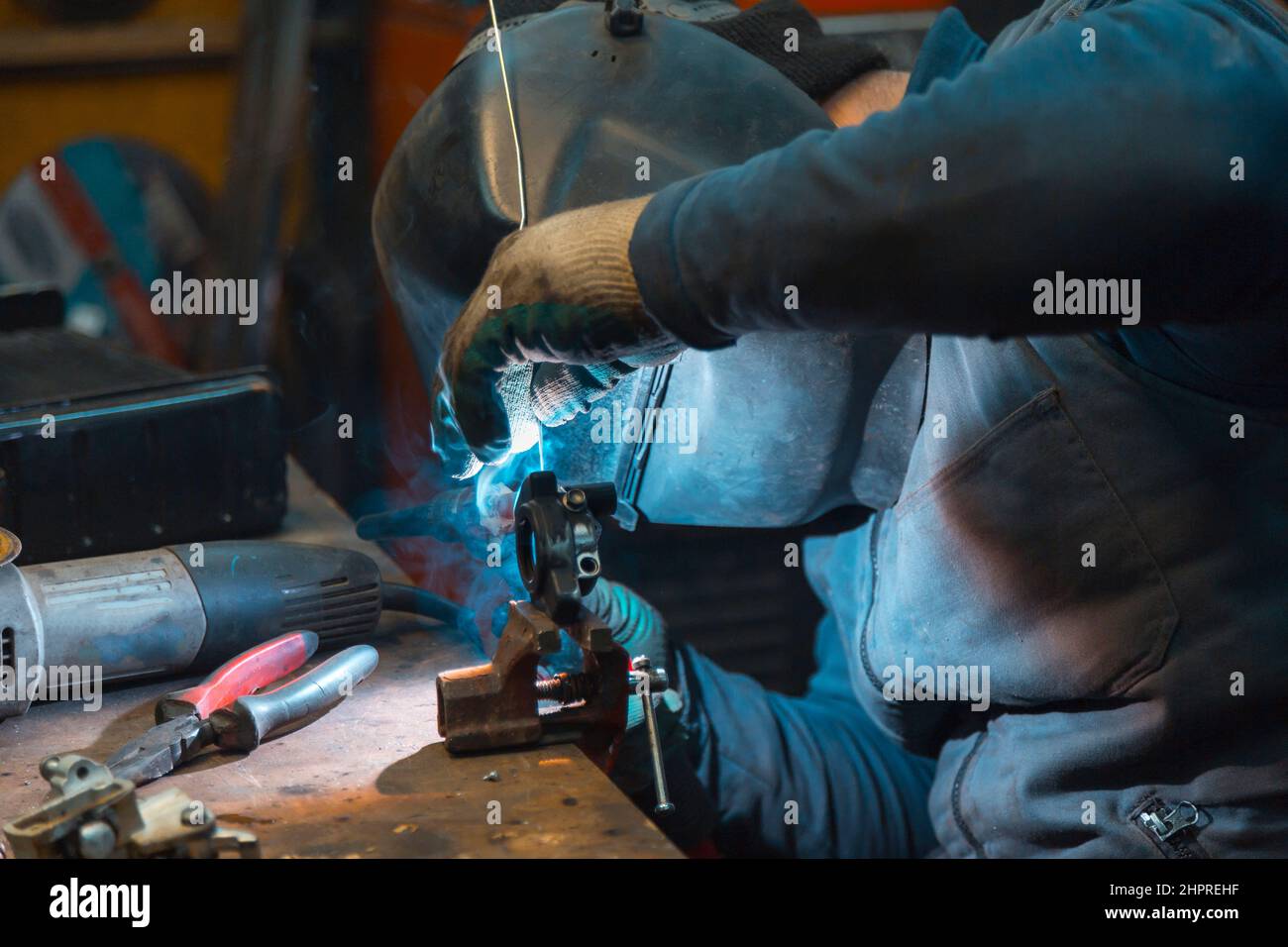 TIG welder welds an aluminum part of a car Stock Photo - Alamy