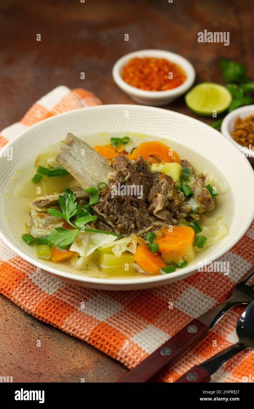 Sop Tulang Sapi or Indonesian clear beef soup mixed with some ...
