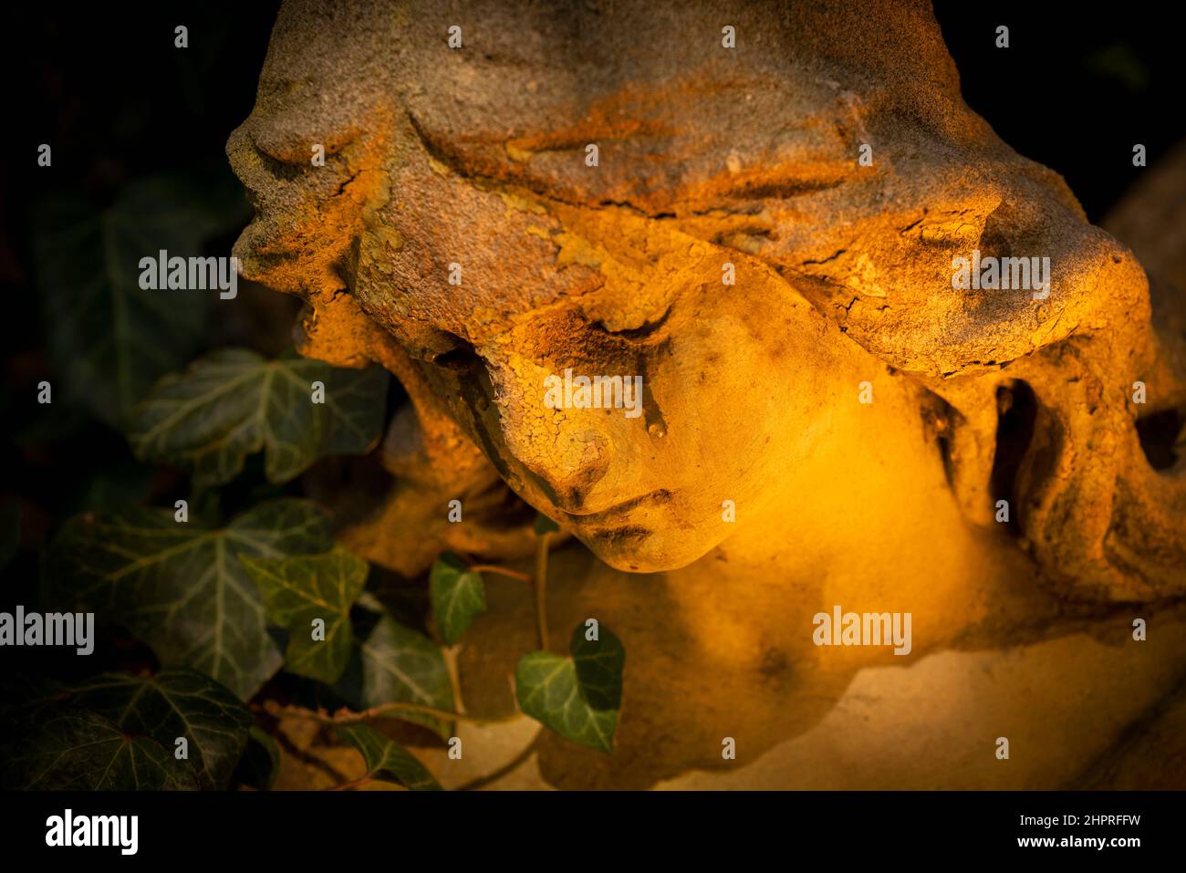 Death concept. Beautiful gold angel is crying . Fragment of an ancient ...