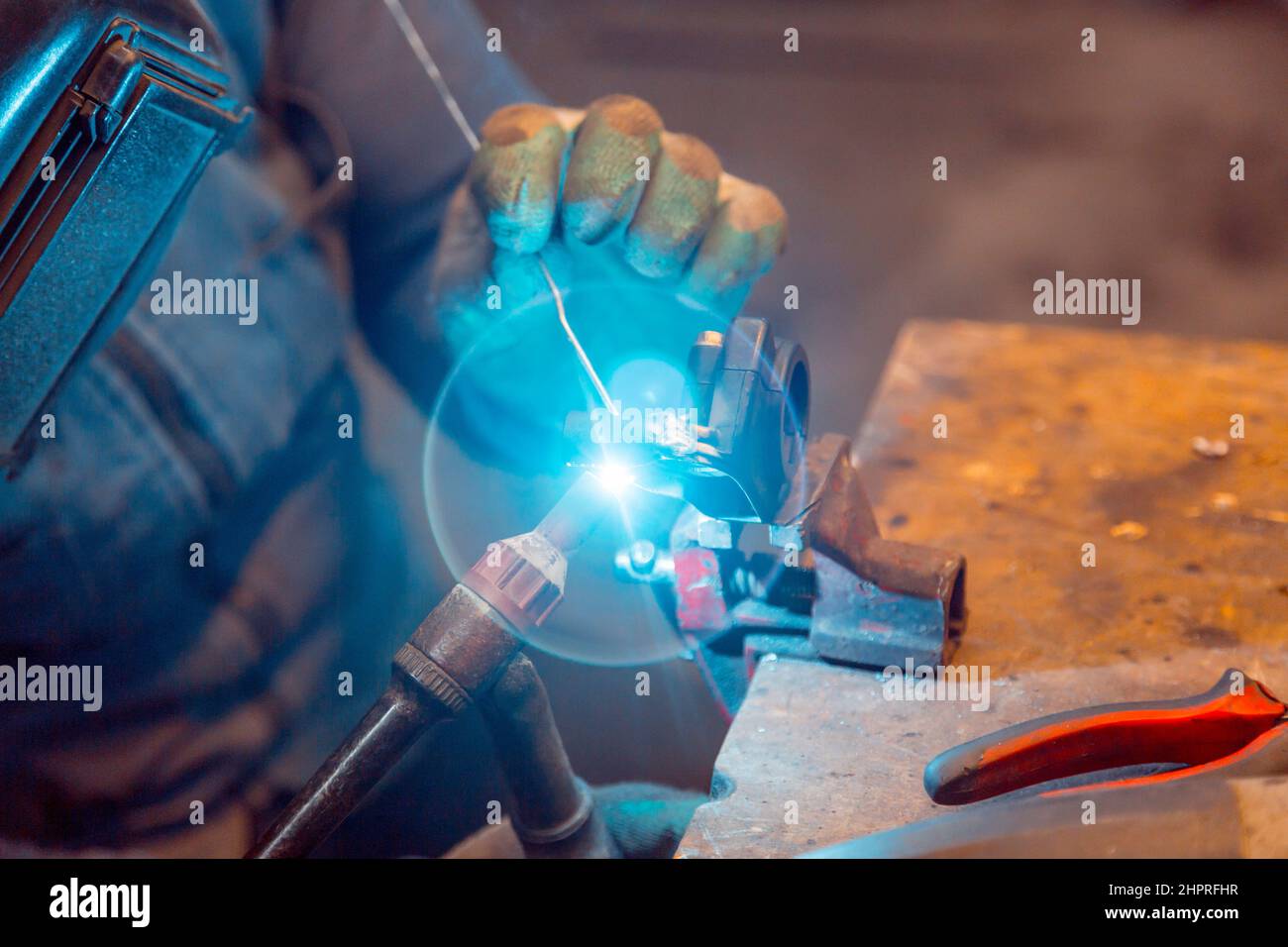 TIG welder welds an aluminum part of a car Stock Photo - Alamy